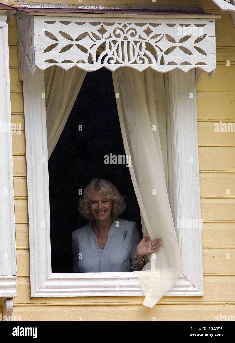 Camilla, Duchess of Cornwall peeps out of a window at Fondoux Cocoa ...