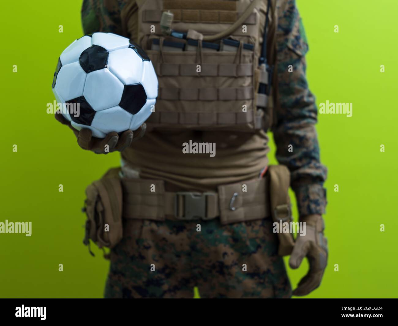 solder holding soccer ball ready for game concept of peace and sport in ...