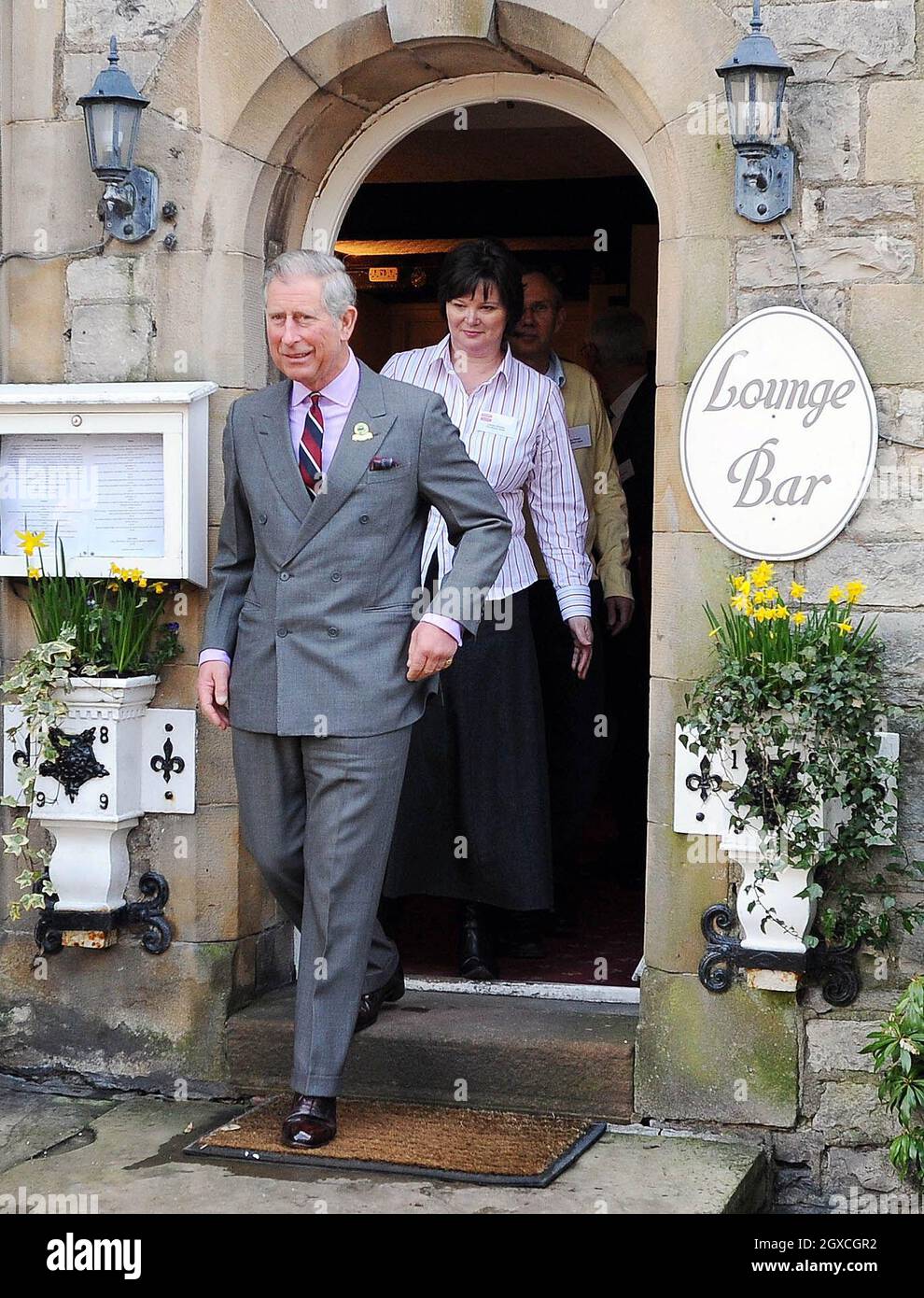 Prince Charles, Prince of Wales walks with Louise Dinnes, owner of the ...