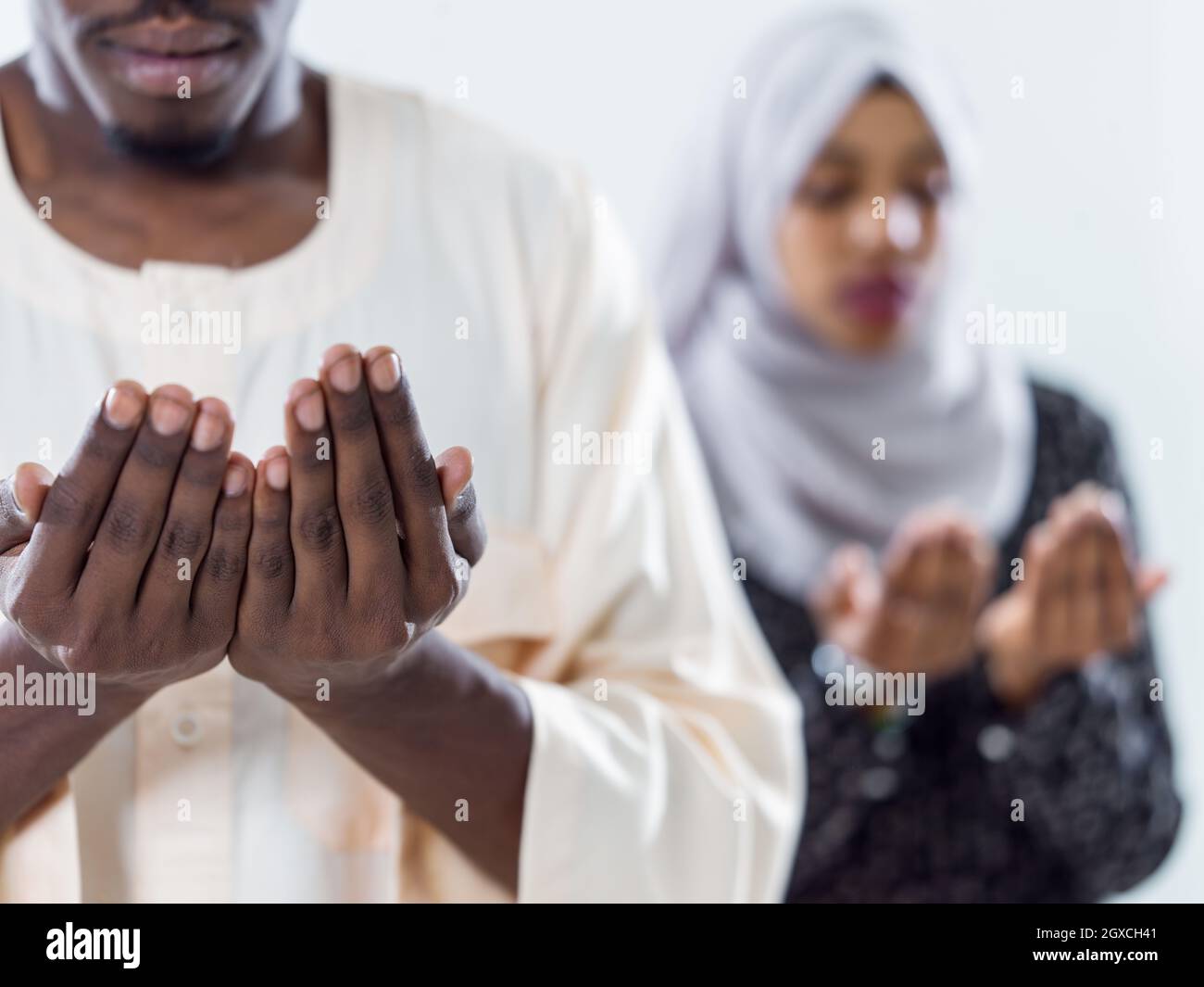 african muslim couple praying Allah by raising hands and making fatiha ...