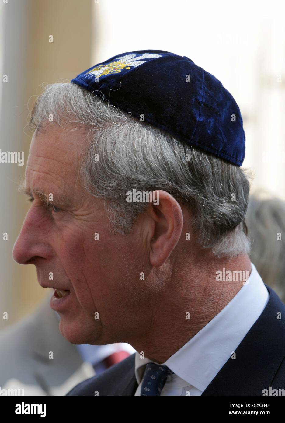 Prince Charles, Prince of Wales, wearing a Jewish yarmulka, attends the ...