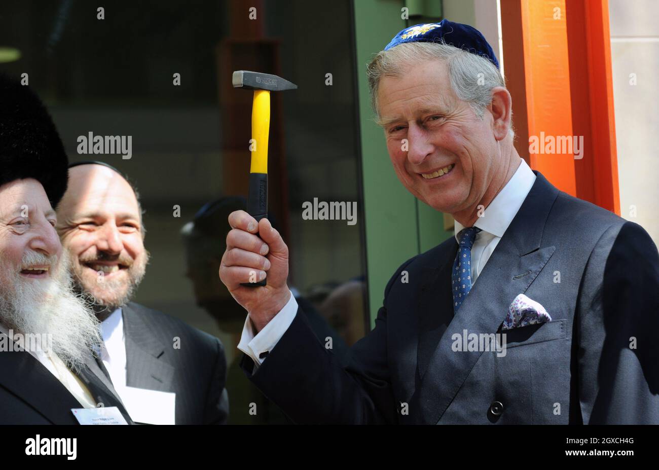 Prince Charles, Prince of Wales, wearing a Jewish yarmulka, smiles as ...