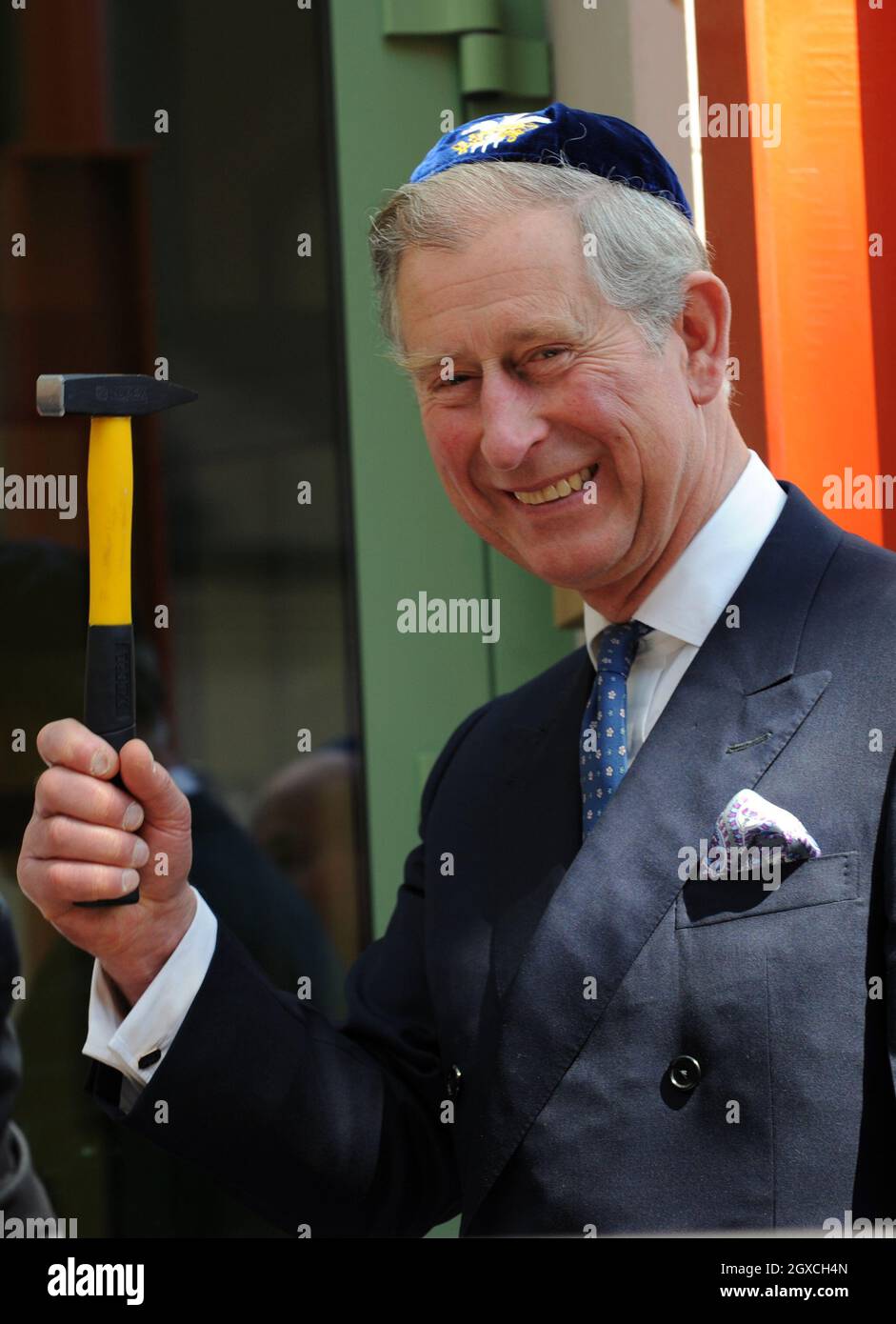 Prince Charles, Prince of Wales, wearing a Jewish yarmulka, smiles as ...