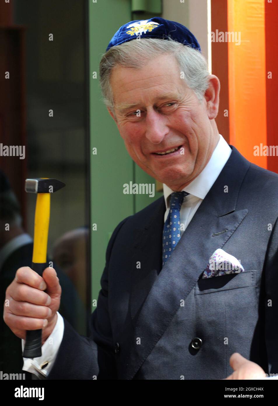 Prince Charles, Prince of Wales, wearing a Jewish yarmulka, smiles as ...