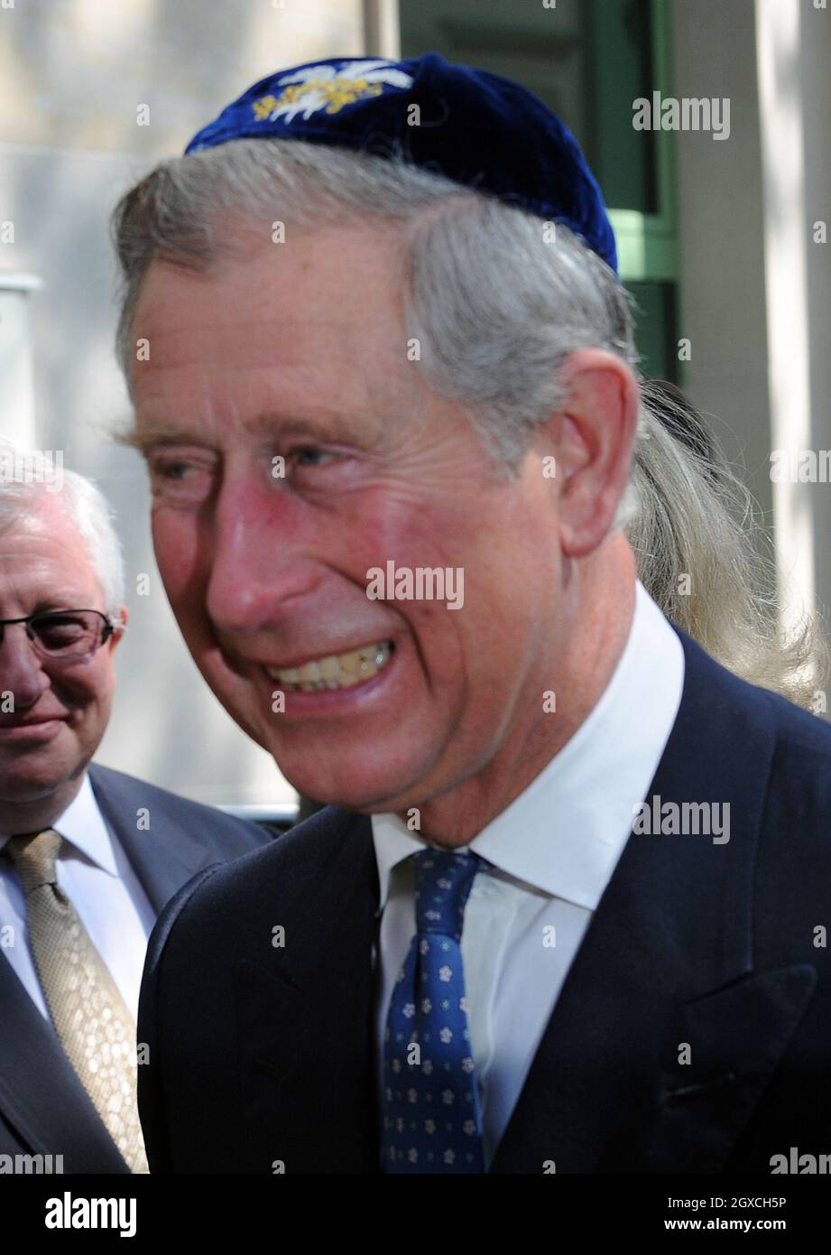 Prince Charles, Prince of Wales, wearing a Jewish yarmulka, smiles as ...