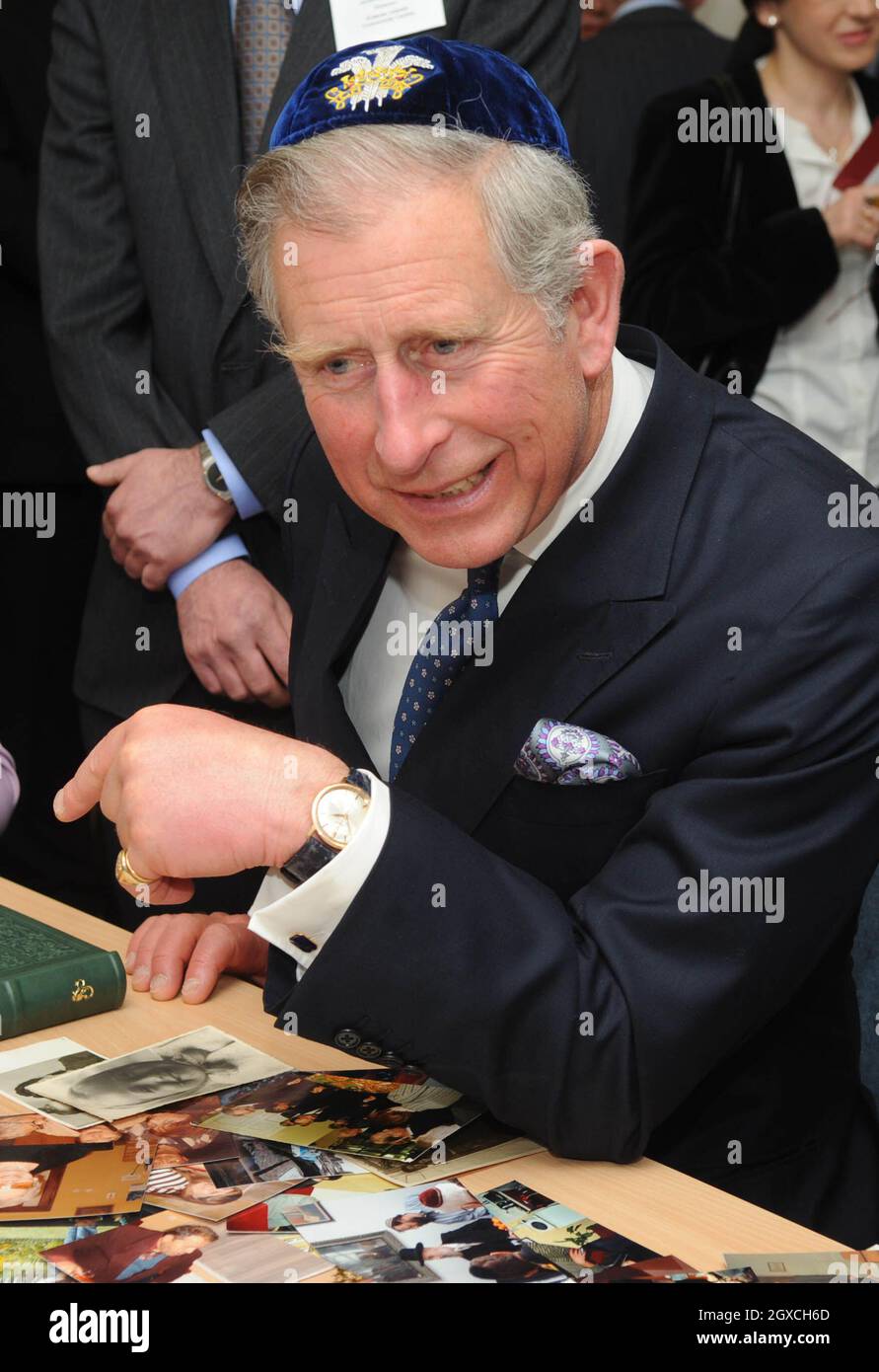 Prince Charles, Prince of Wales, wearing a Jewish yarmulka, looks at ...