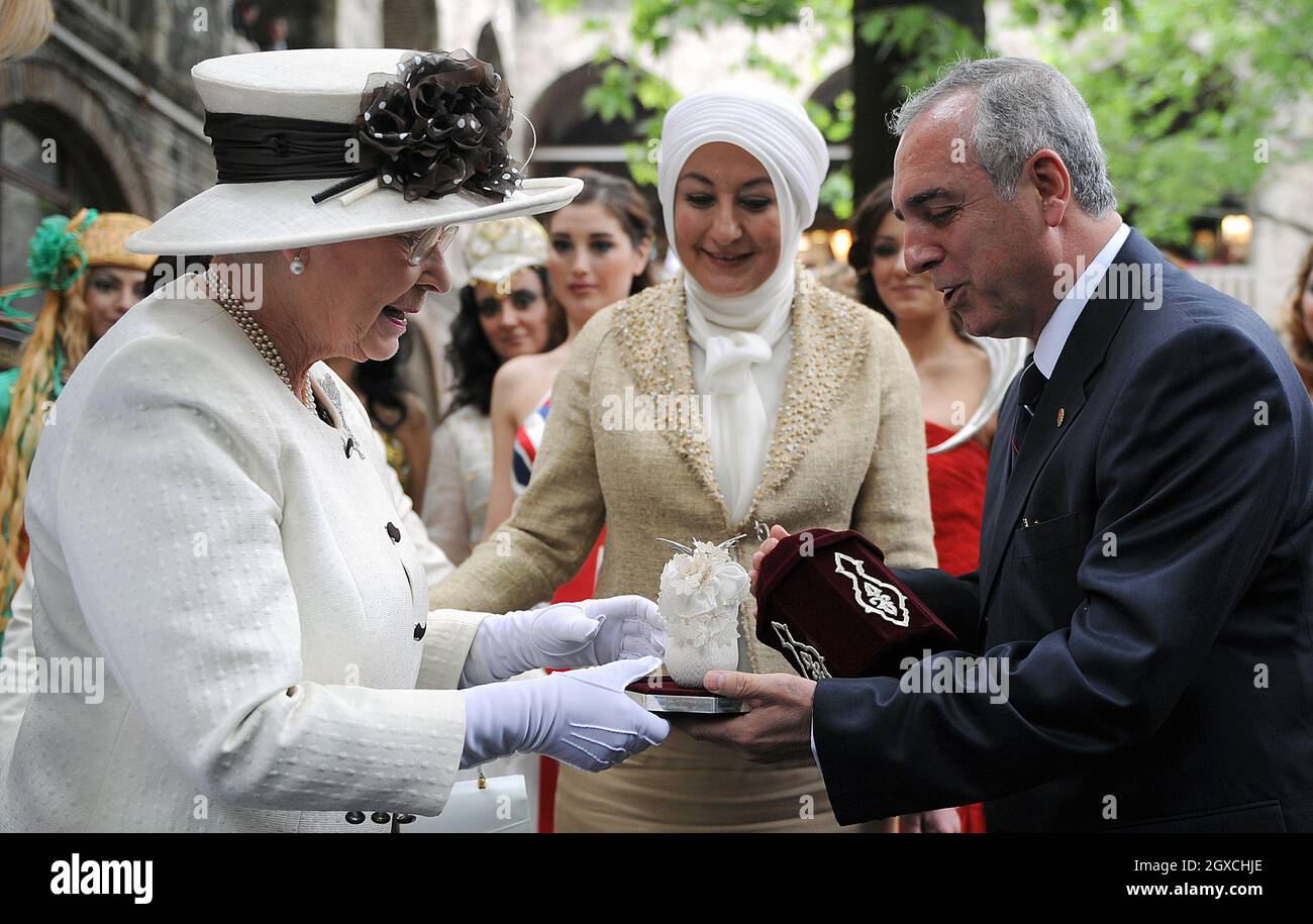 Queen Elizabeth ll receives gifts when she attends a fashion show with ...