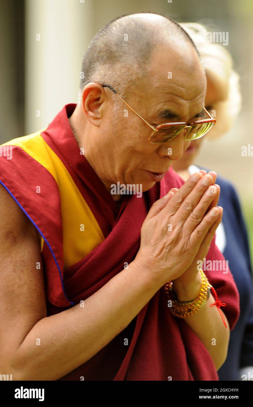The Dalai Lama plants a tree at Clarence House in London Stock Photo ...