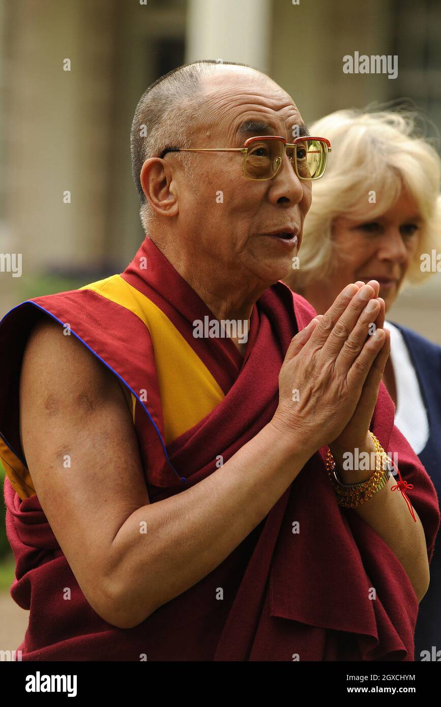 The Dalai Lama plants a tree at Clarence House in London Stock Photo ...