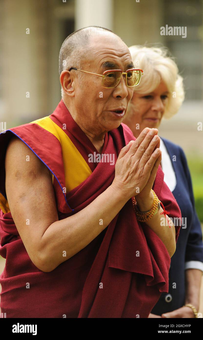The Dalai Lama plants a tree at Clarence House in London Stock Photo ...