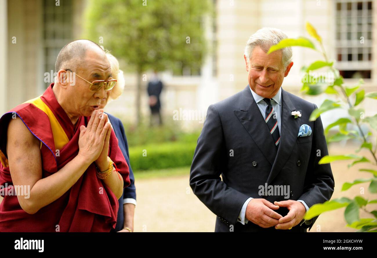 The Dalai Lama plants a tree at Clarence House in London Stock Photo ...