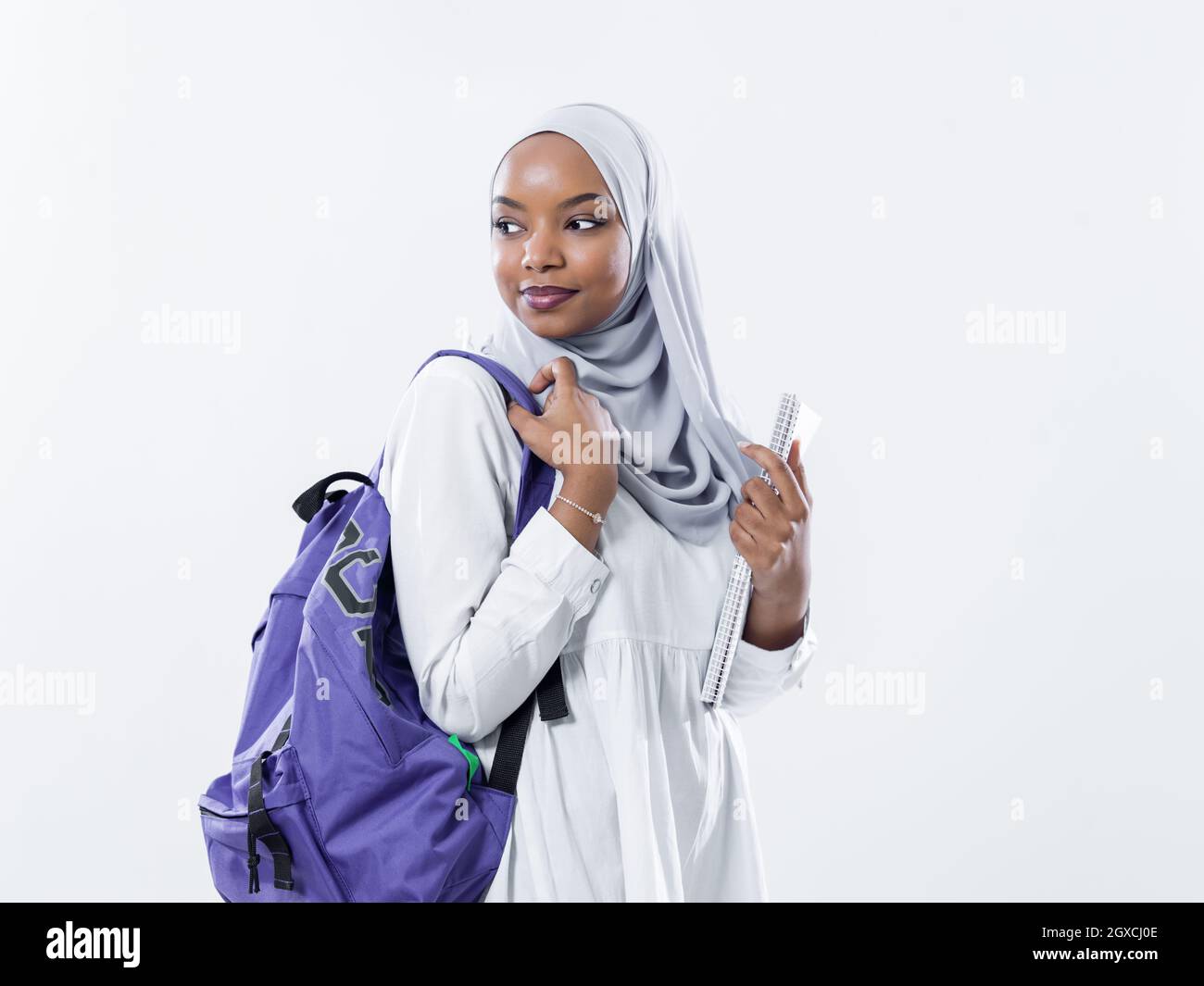 portrait of happy african modern muslim female student standing against ...