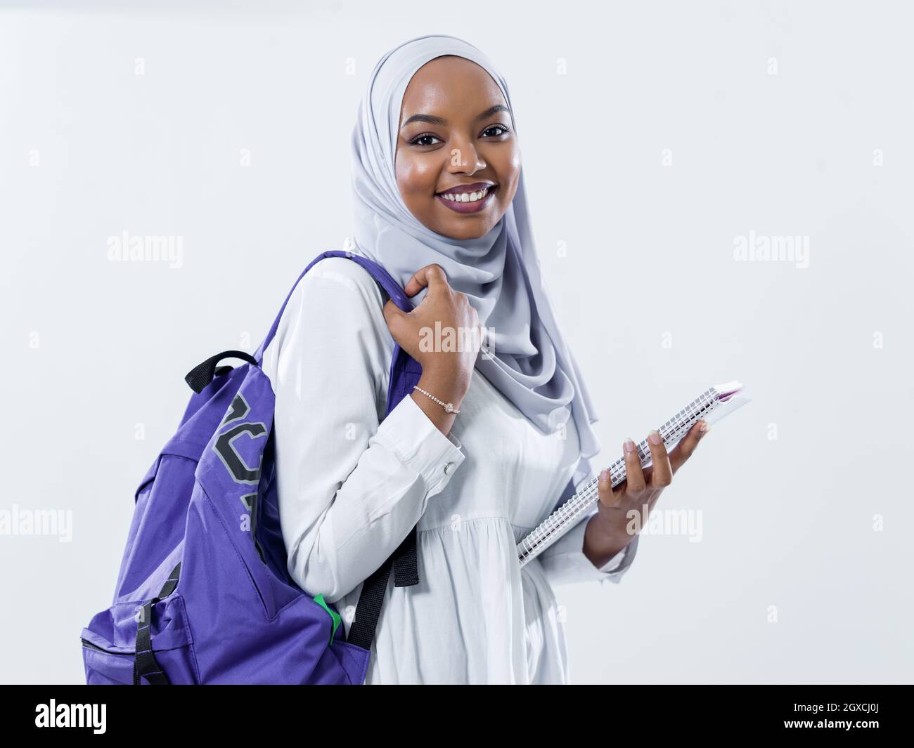portrait of happy african modern muslim female student standing against ...