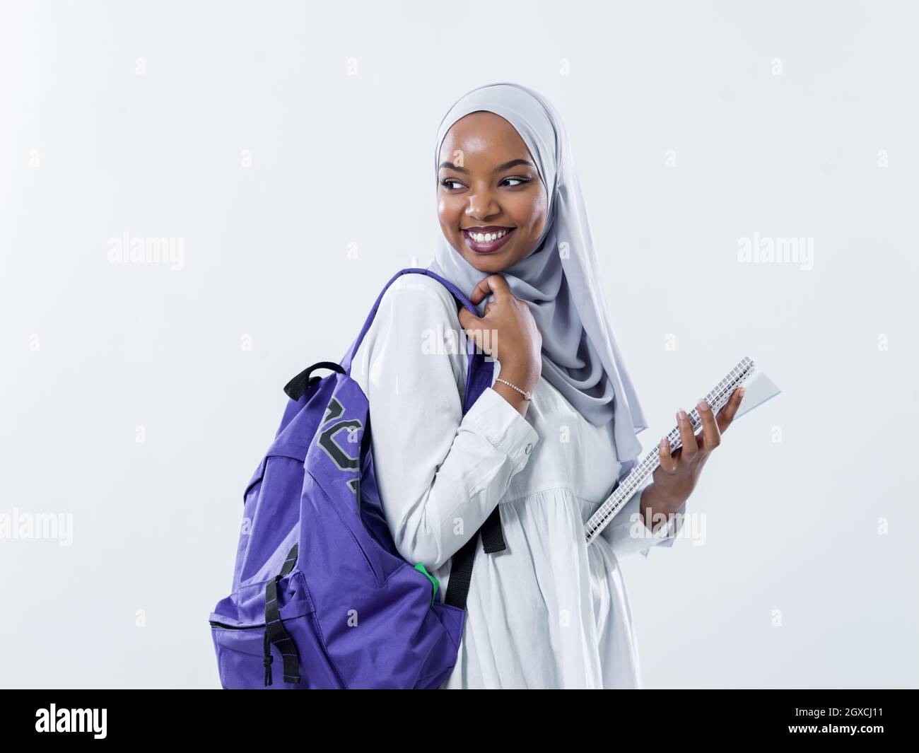 portrait of happy african modern muslim female student standing against ...