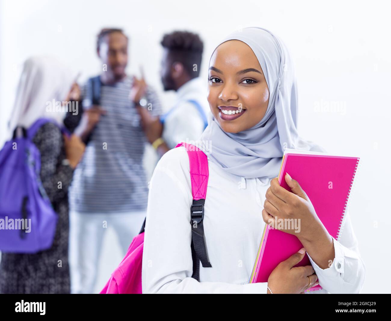 portrait of young african modern muslim female student with group of ...