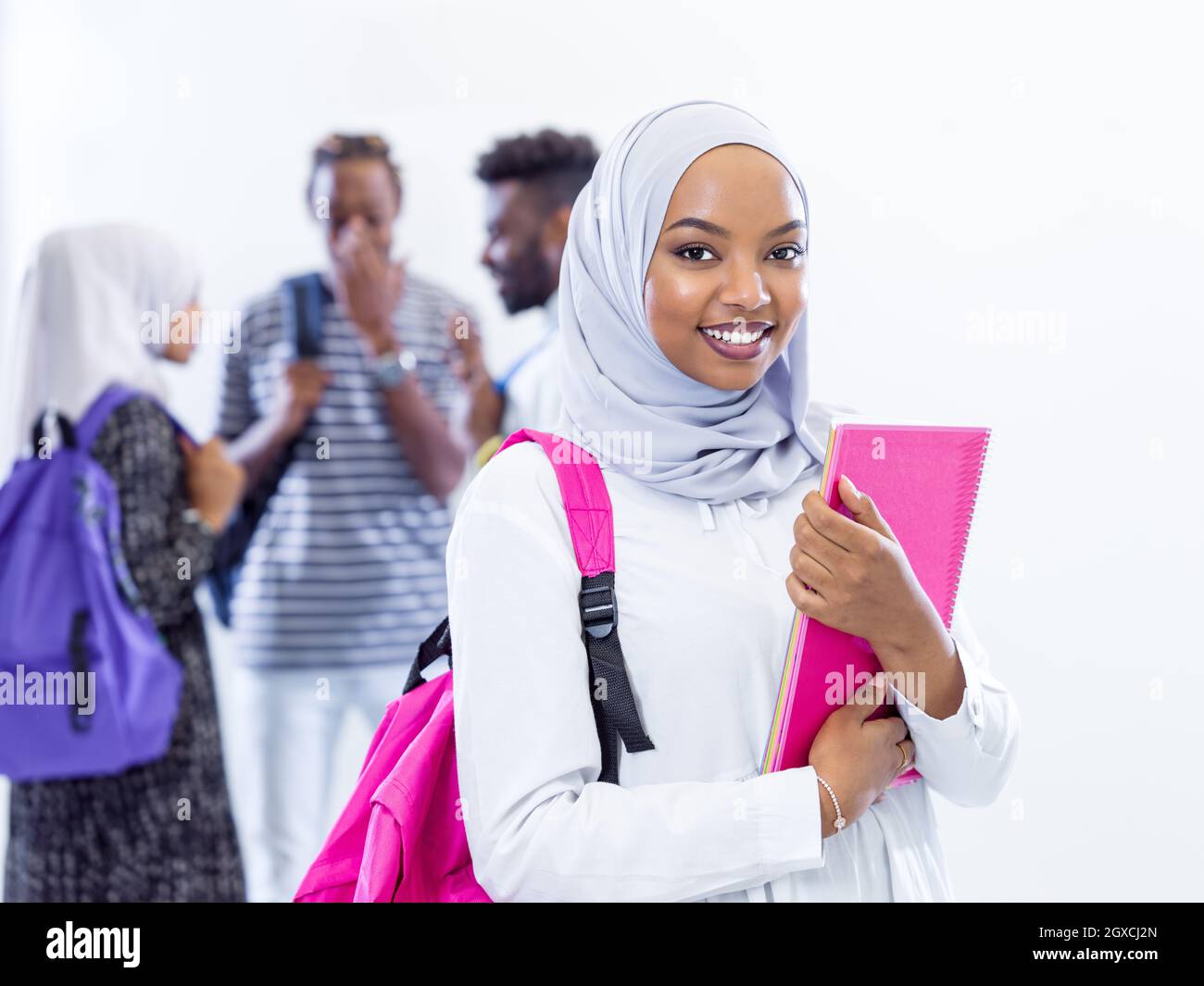 portrait of young african modern muslim female student with group of ...