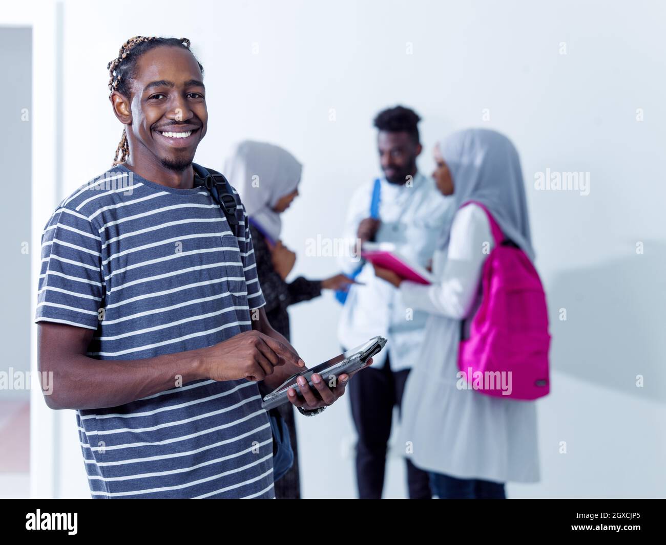 university lifestyle handsome young african student man holding tablet ...