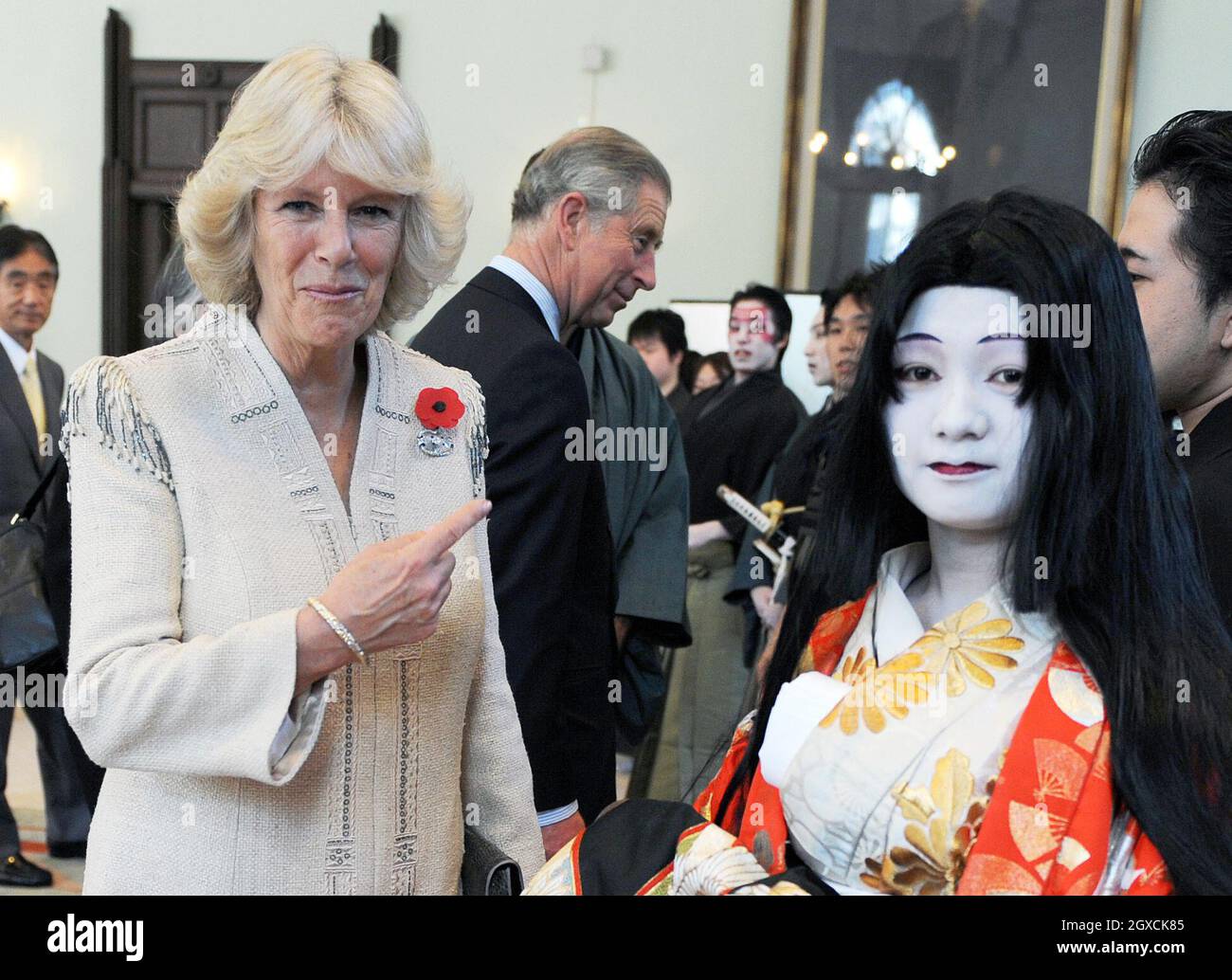 Camilla, Duchess of Cornwall poses at a traditionally dressed actress ...