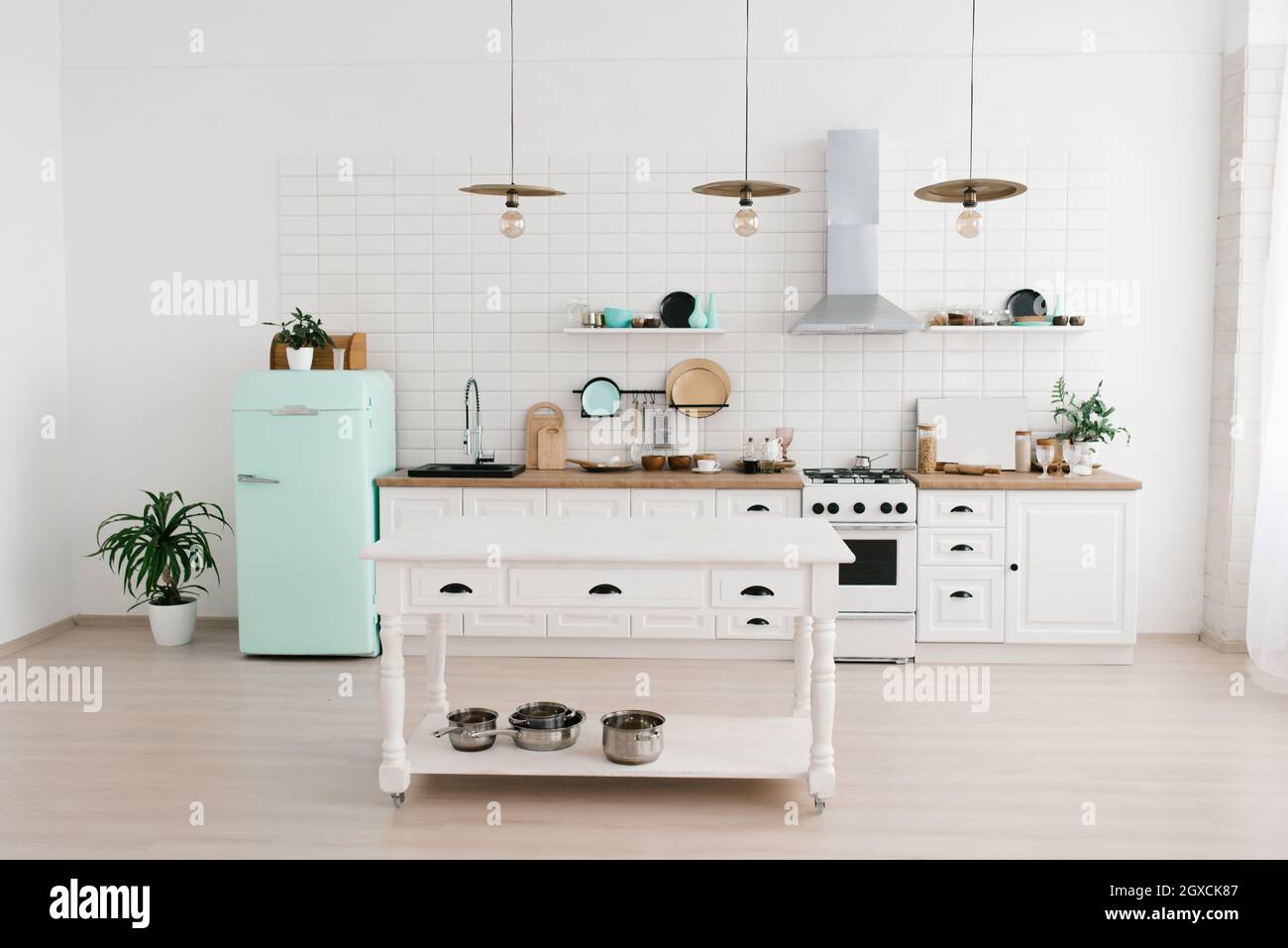 Bright Scandinavian-style kitchen with mint-colored refrigerator Stock ...