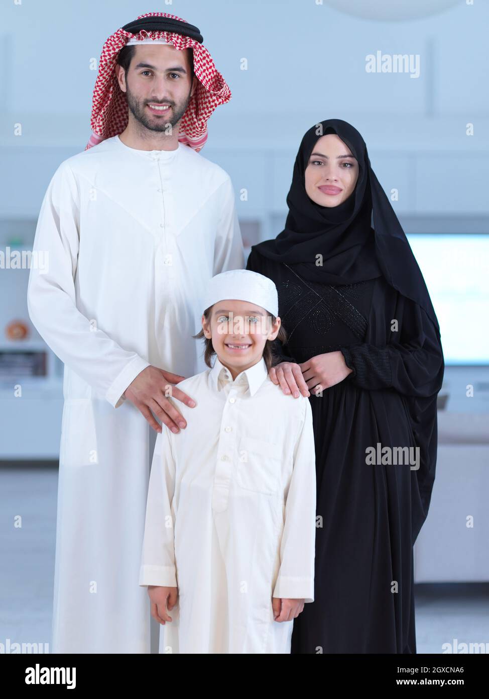 portrait of young happy arabian muslim family couple with son in ...