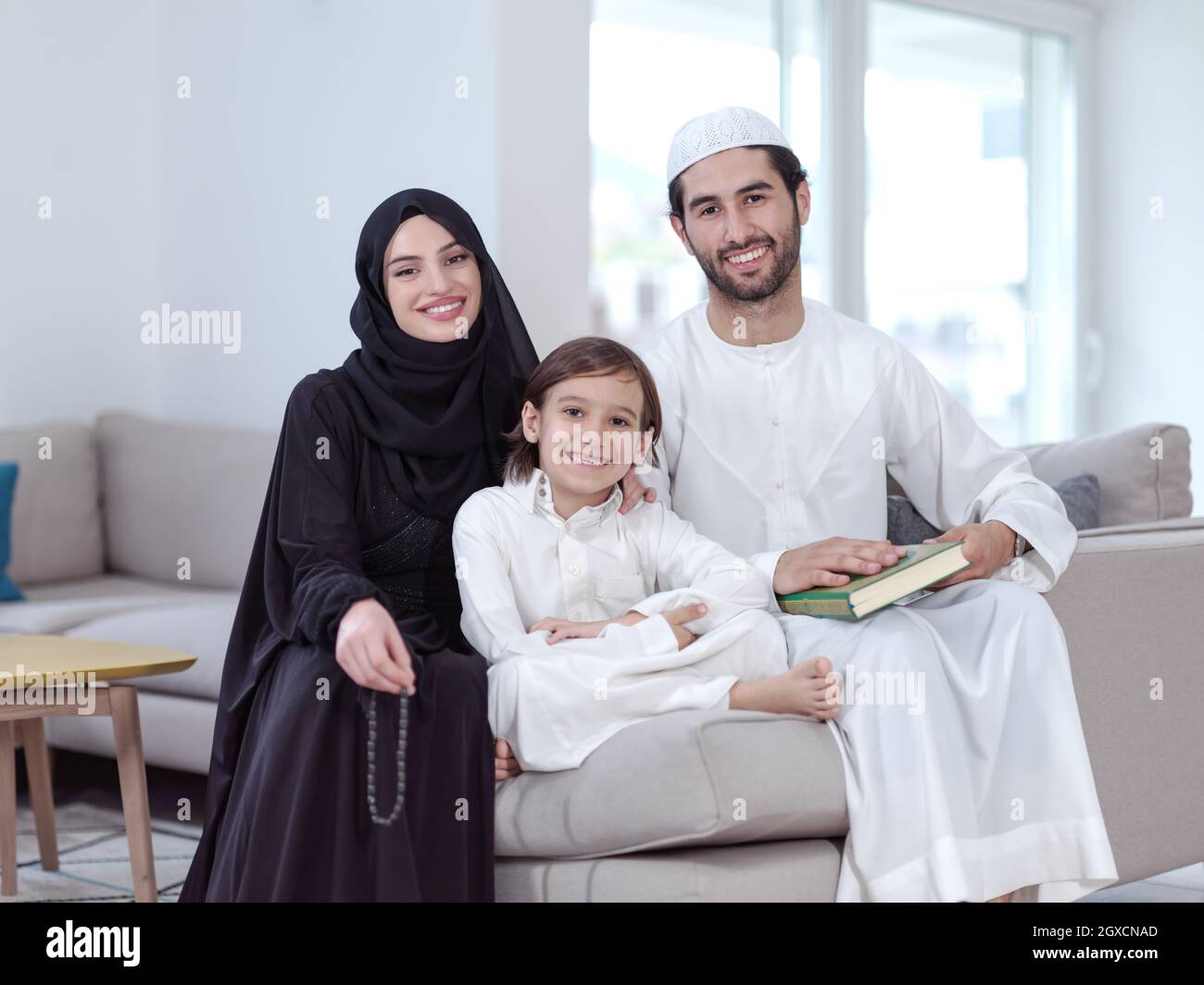 Traditional muslim family parents with children reading Quran and ...