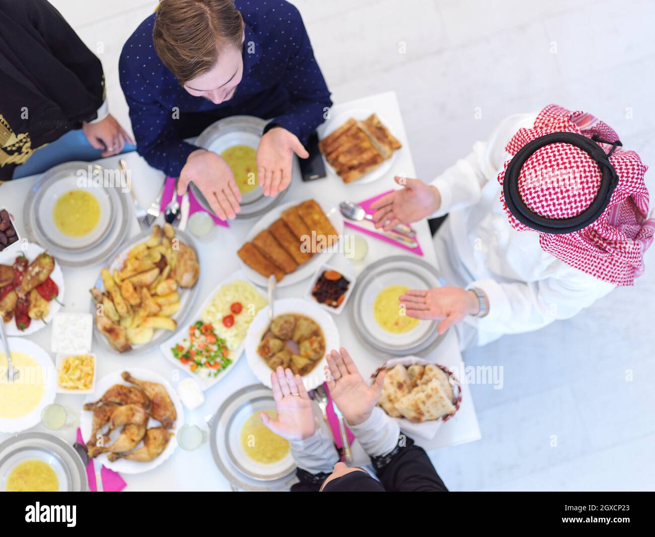 Eid Mubarak Muslim people praying before iftar dinner. Eating ...