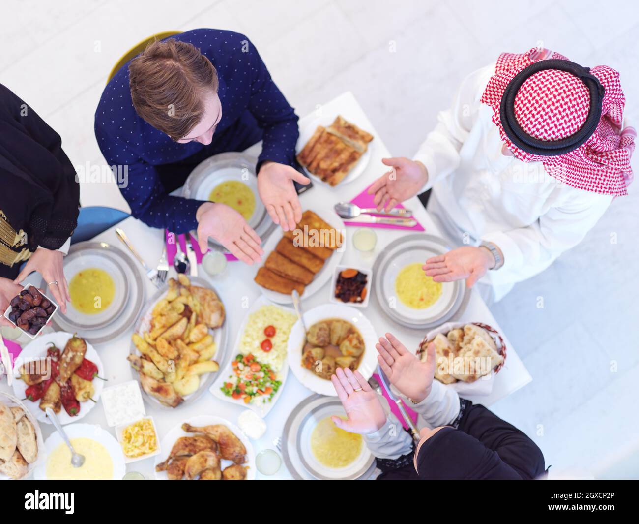 Eid Mubarak Muslim people praying before iftar dinner. Eating ...