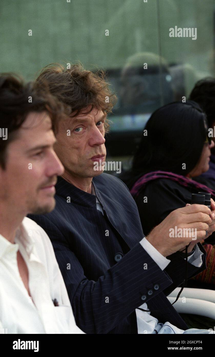 Mick Jagger (r) of rock and roll band The Rolling Stones watches the ...