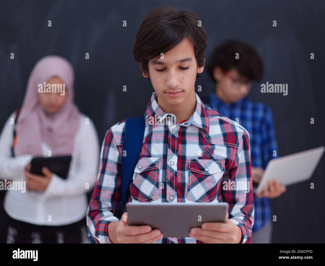 Arabic teenagers team, students group working together on laptop and ...