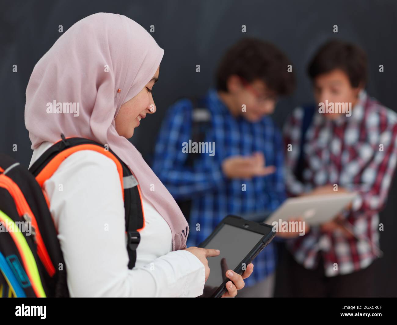 Arabic teenagers team, students group working together on laptop and ...