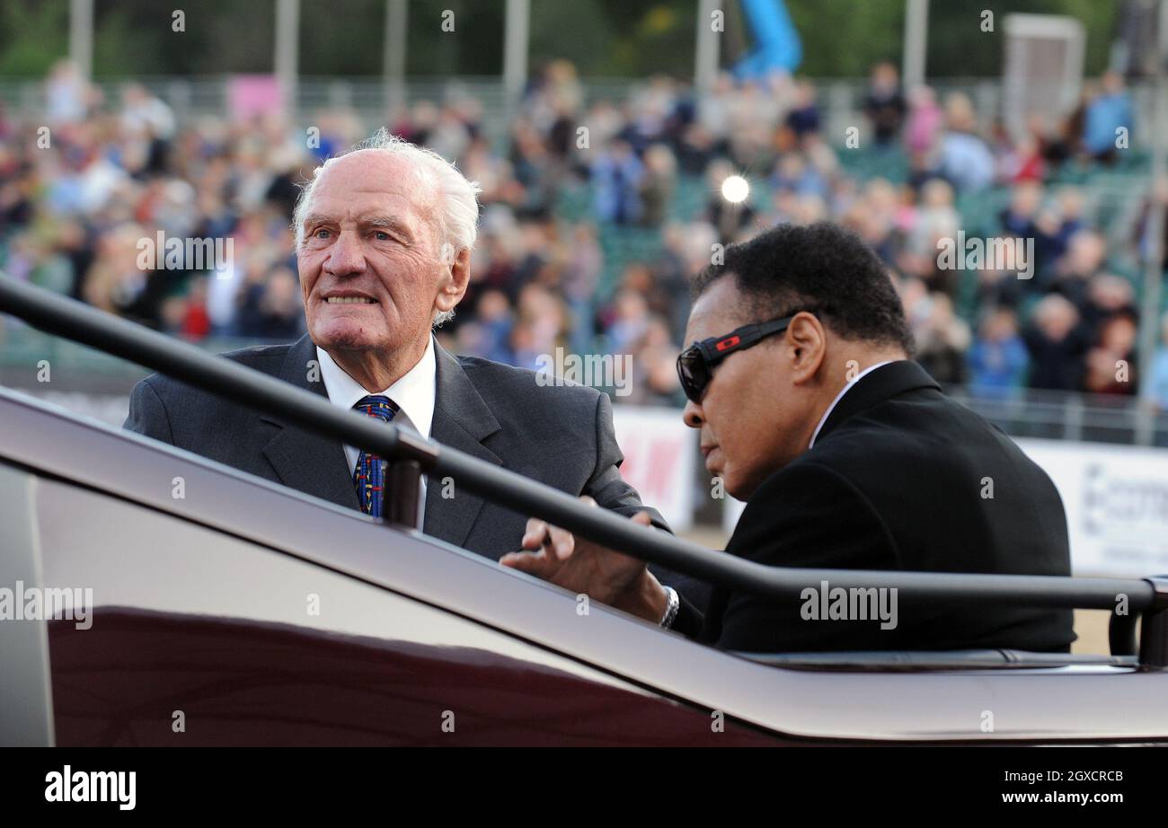 Boxers Muhammad Ali and Sir Henry Cooper parade round the ring in the ...