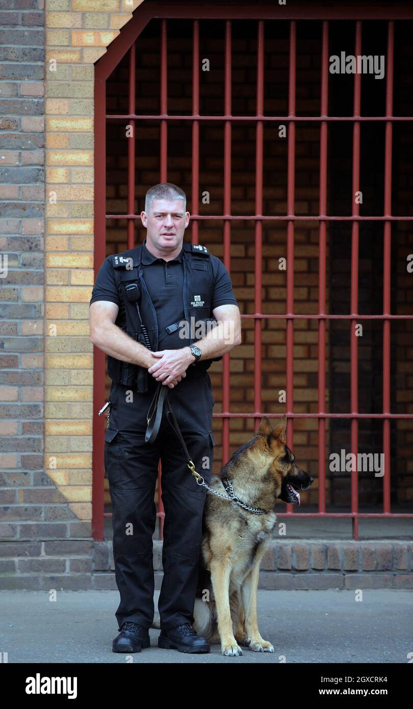A prison guard and guard dog are seen outside Belmarsh (HM Prison) in ...