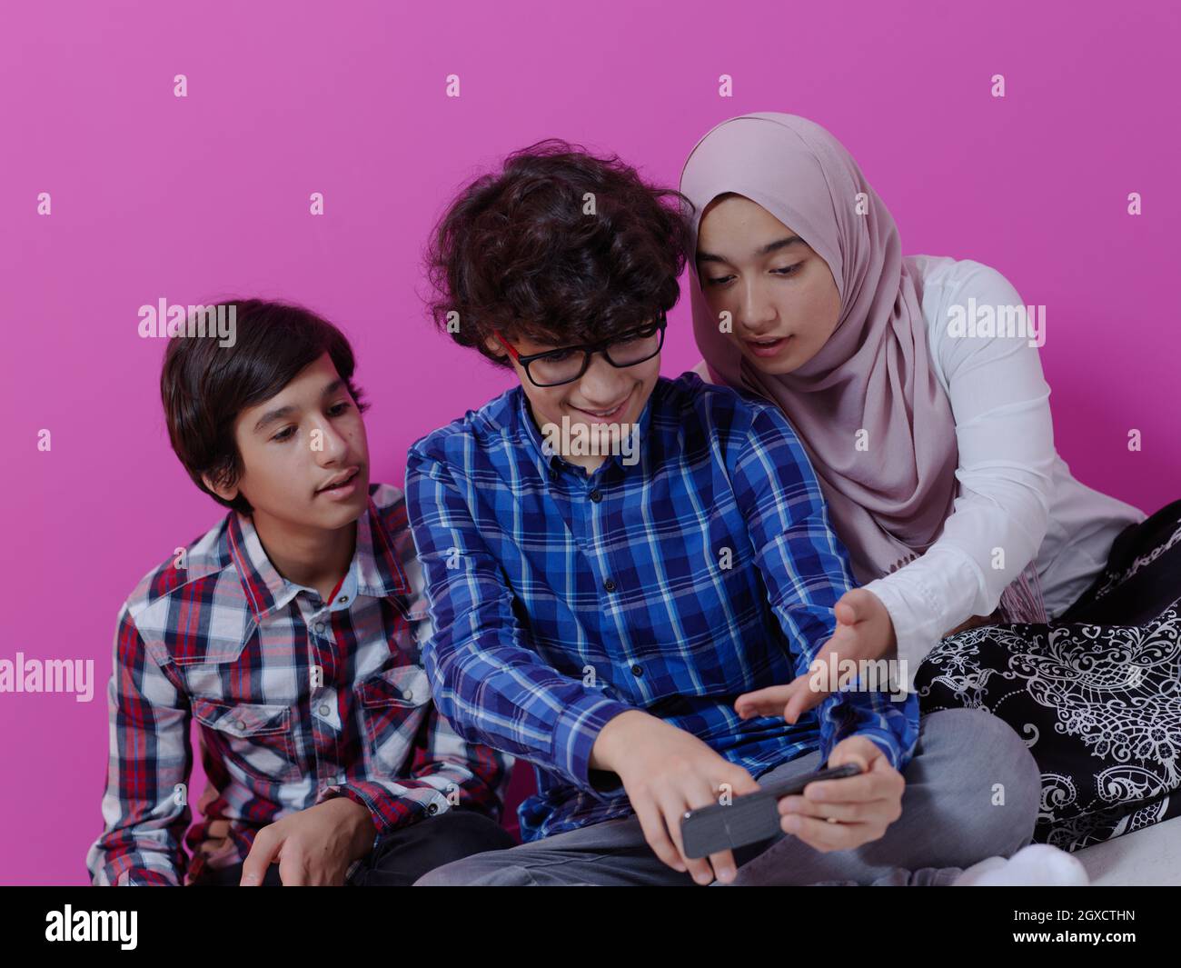 arab teenagers group using smart phones for social media networking and ...