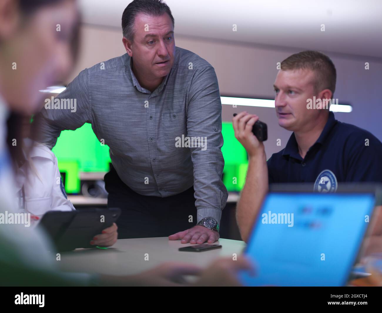 Group of security guards sitting and having briefing In the system ...
