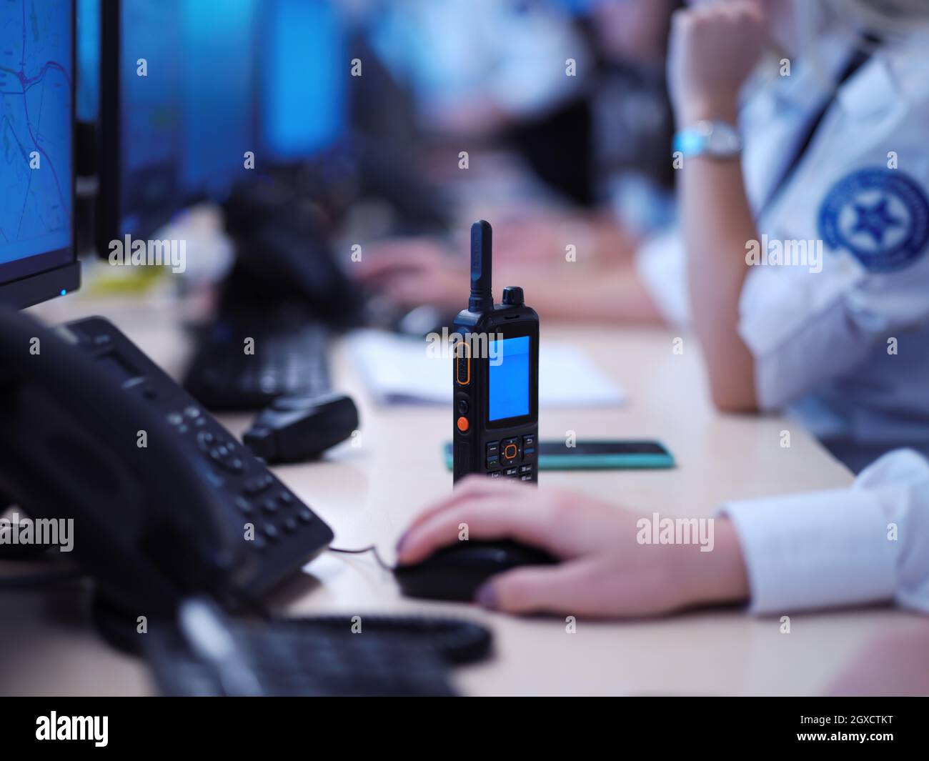 Female security operator working in a data system control room offices ...