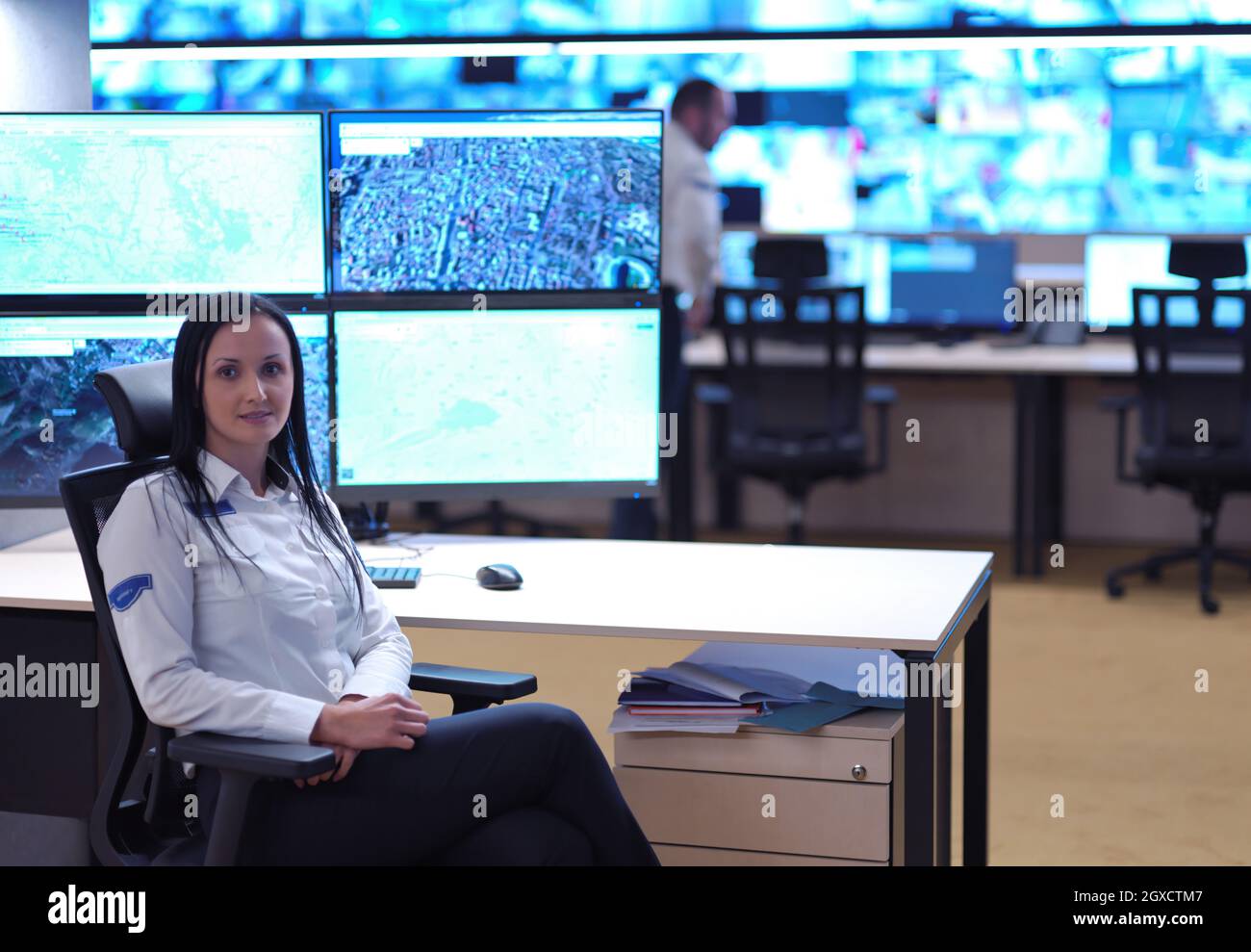 portrait of female security operator while working in a data system ...