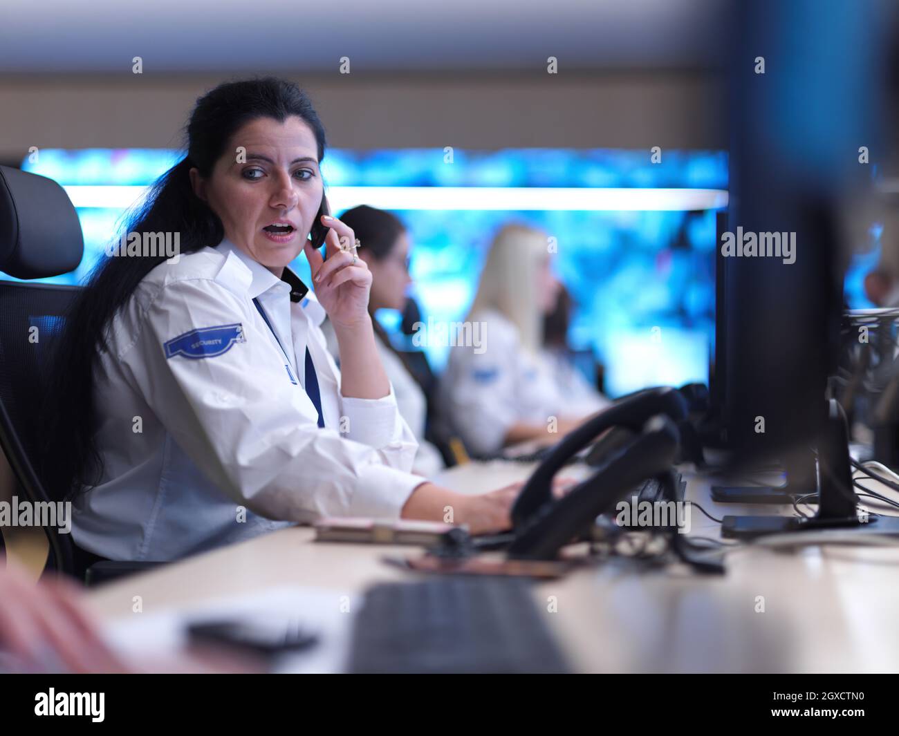 group of female security operators working in a data system control ...