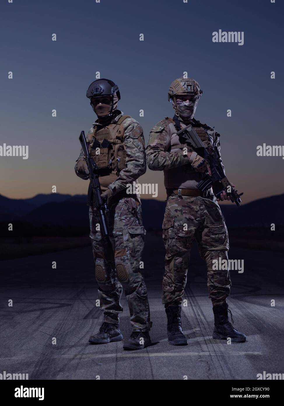 Two heavily armed special forces soldiers in full protective military ...