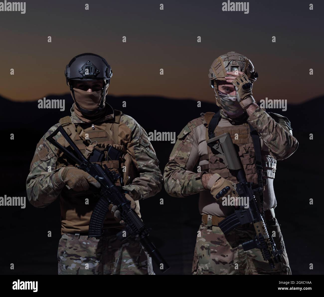 Two heavily armed special forces soldiers in full protective military ...