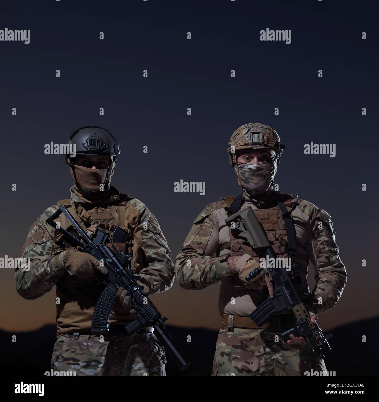 Two heavily armed special forces soldiers in full protective military ...