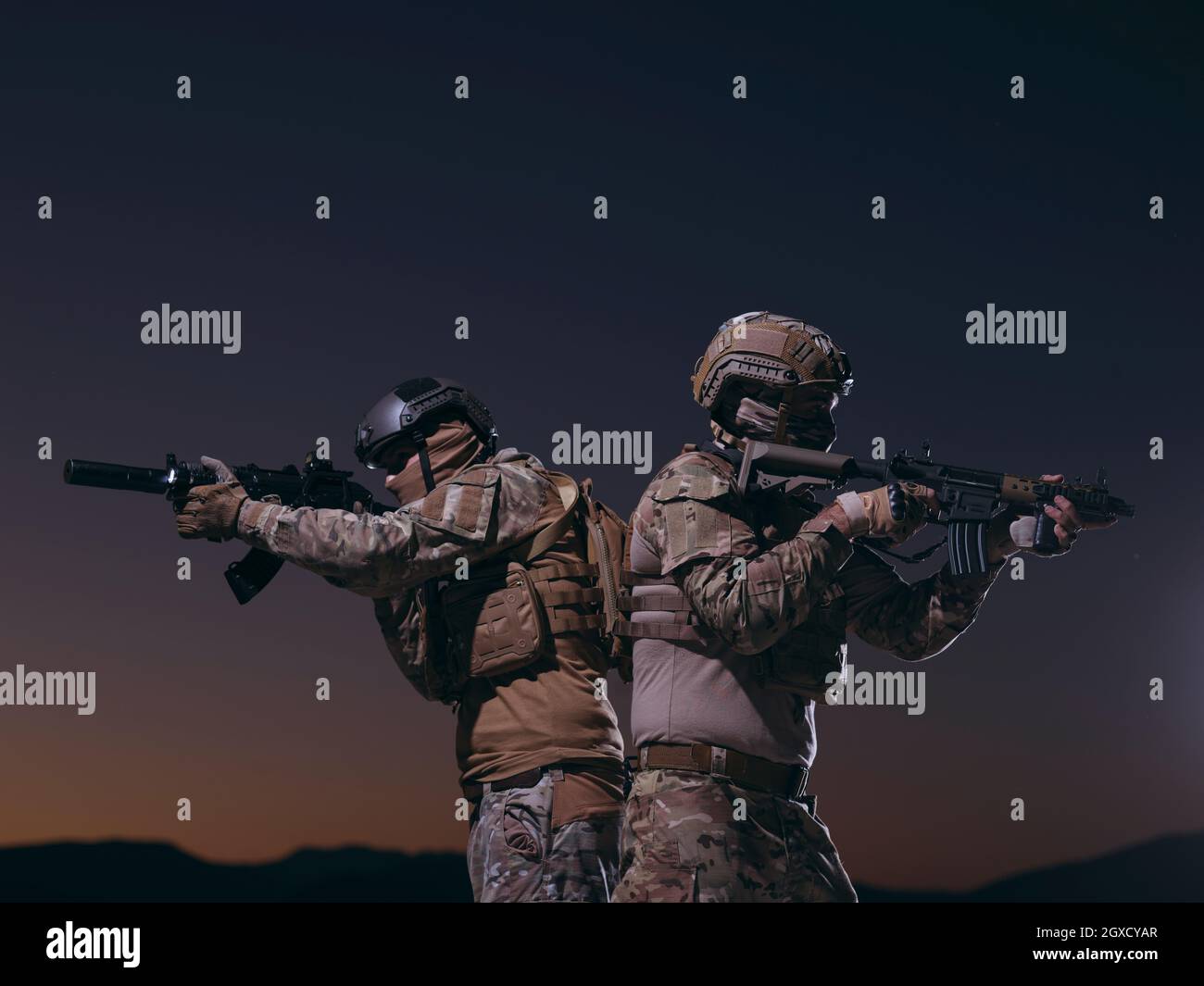 Two heavily armed special forces soldiers in full protective military ...