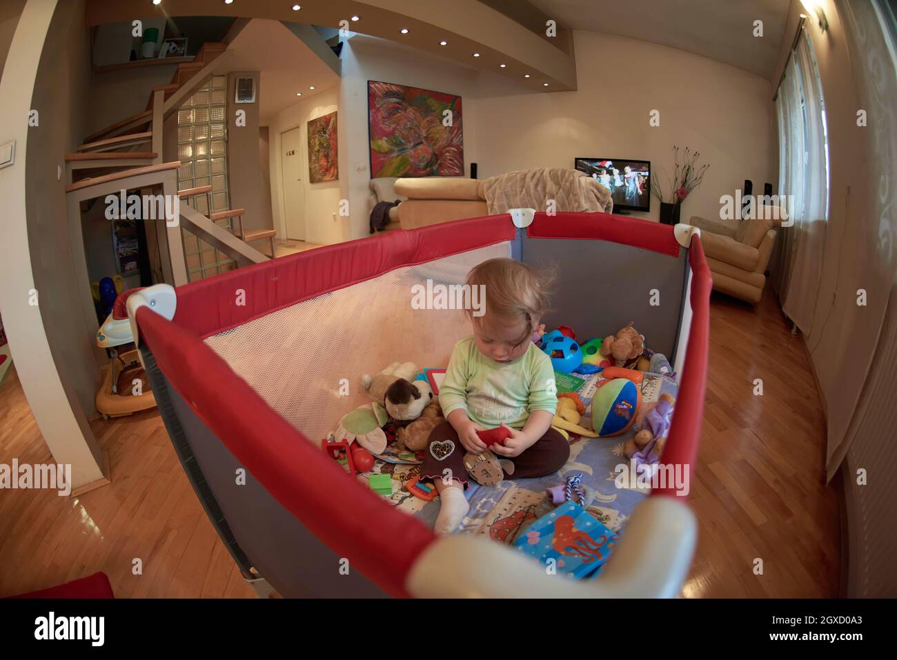 cute little baby playing with toys in mobile bed making first steps and ...