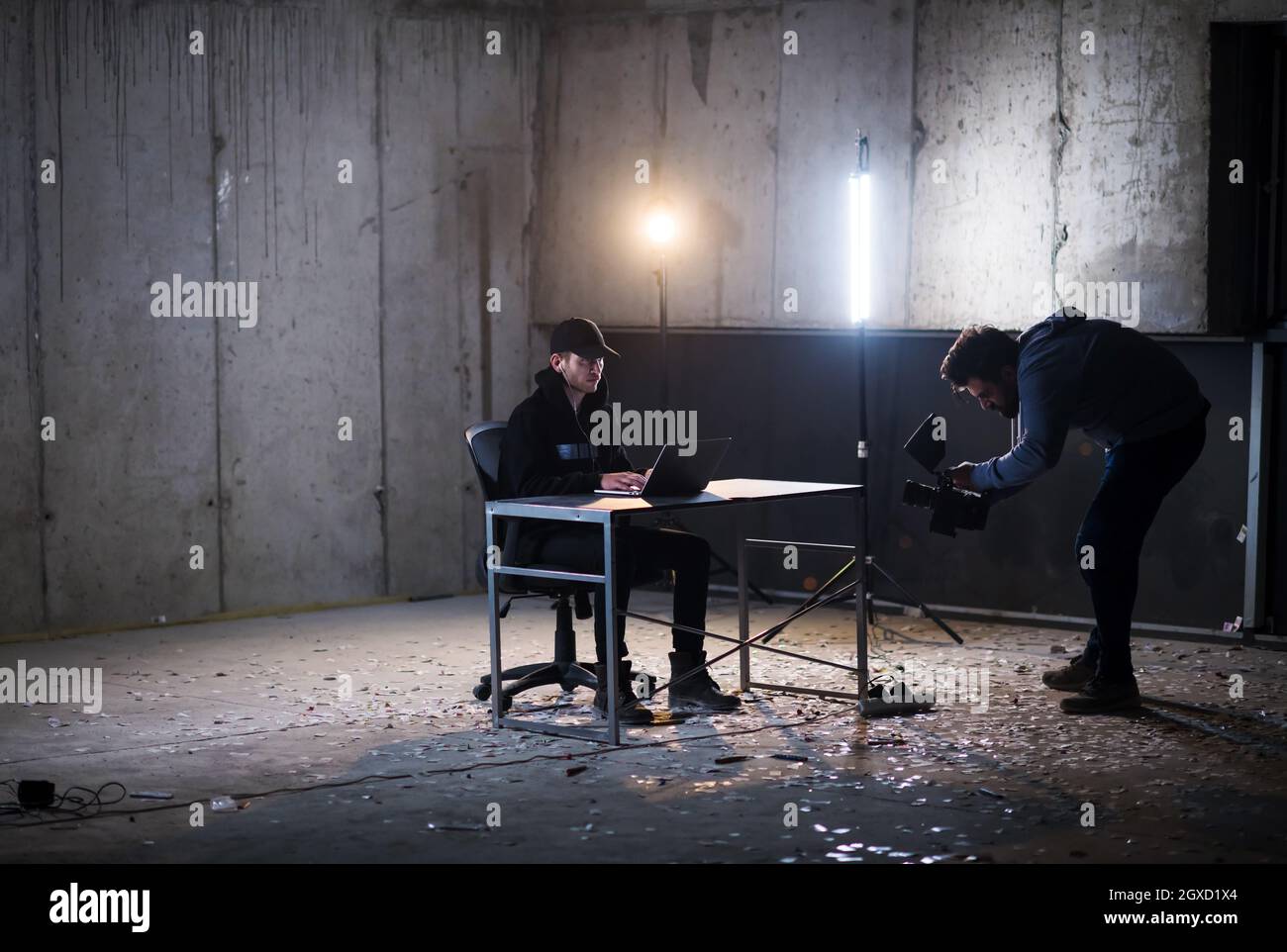 videographer recording young talented hacker while working on laptop ...