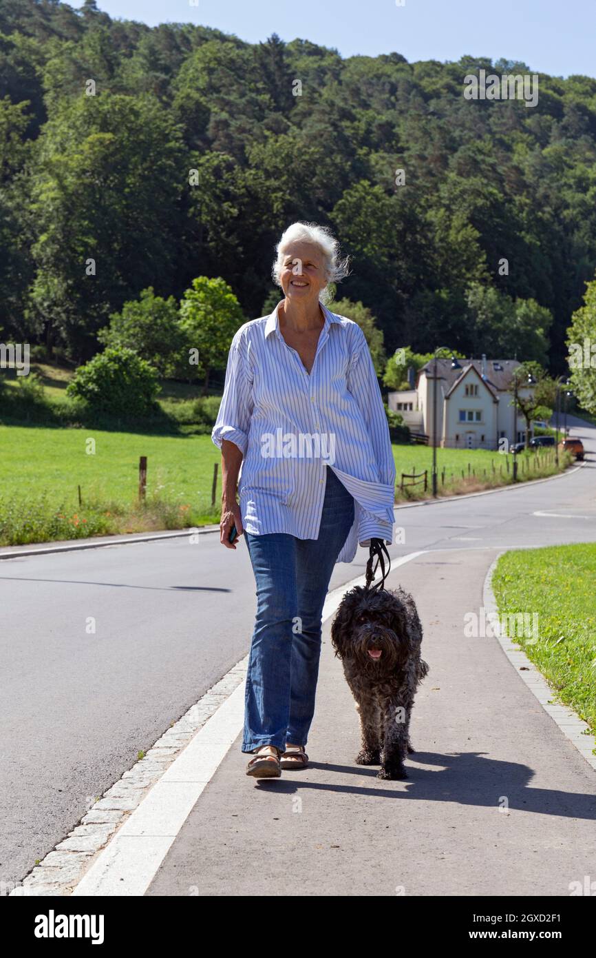 Walking her pet dog hi-res stock photography and images - Alamy