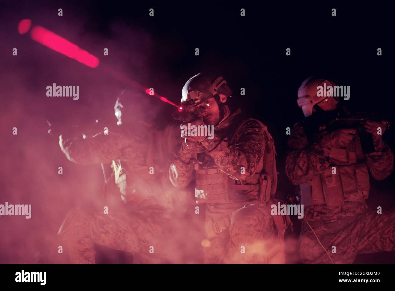 soldiers squad in action on night mission using laser sight beam lights ...