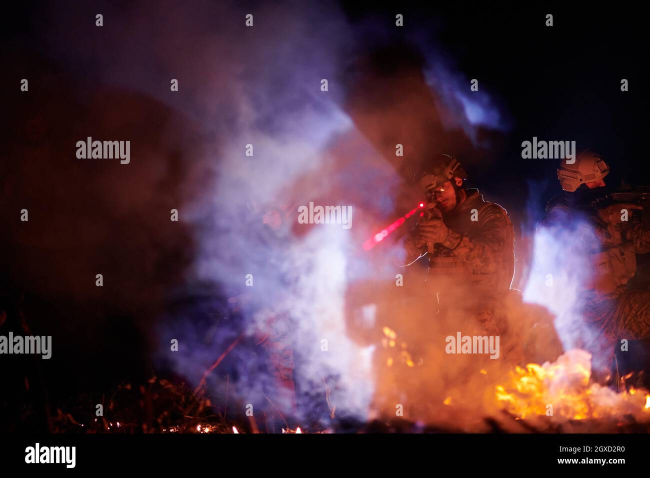soldiers squad in action on night mission using laser sight beam lights ...