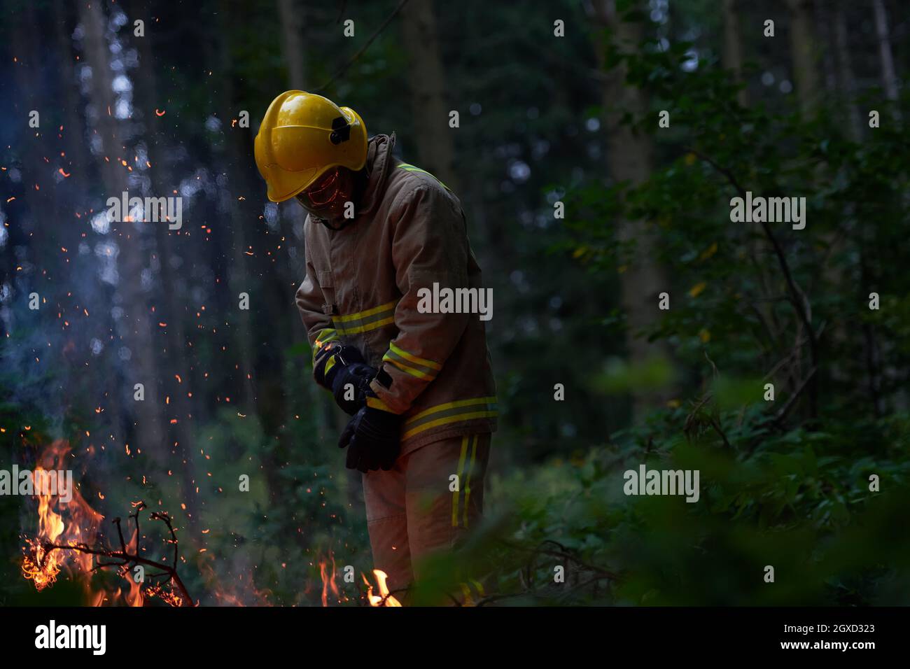 firefighter hero in action danger jumping over fire flame to rescue and ...