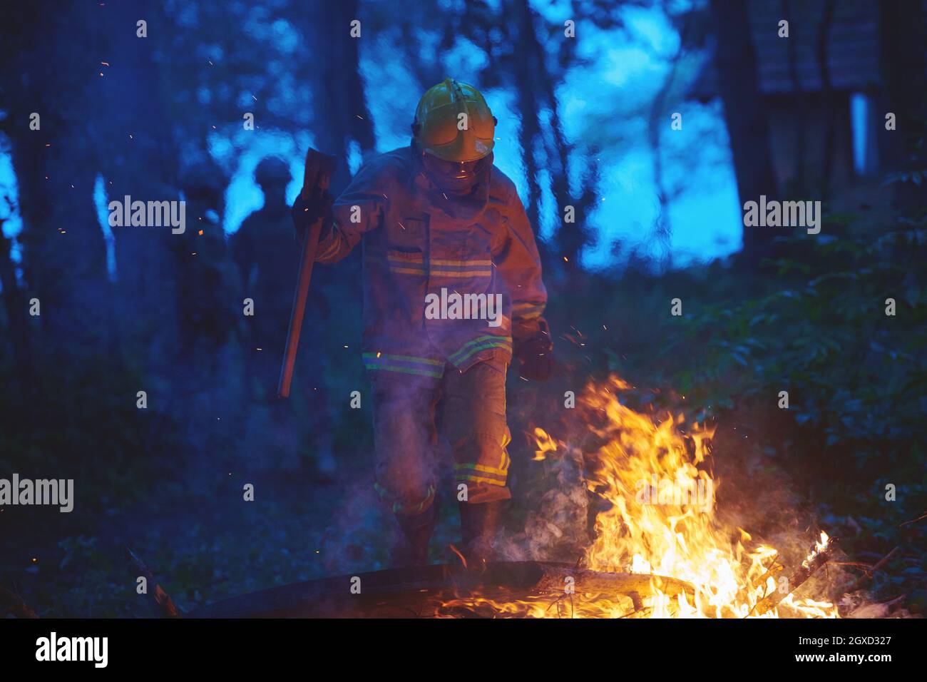 firefighter hero in action danger jumping over fire flame to rescue and ...