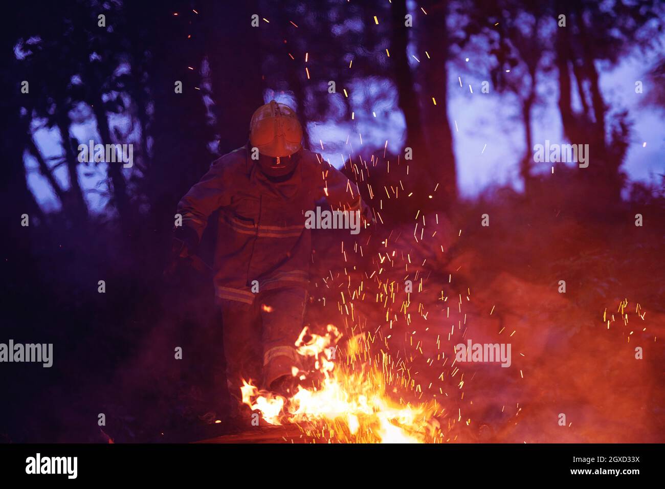 firefighter hero in action danger jumping over fire flame to rescue and ...