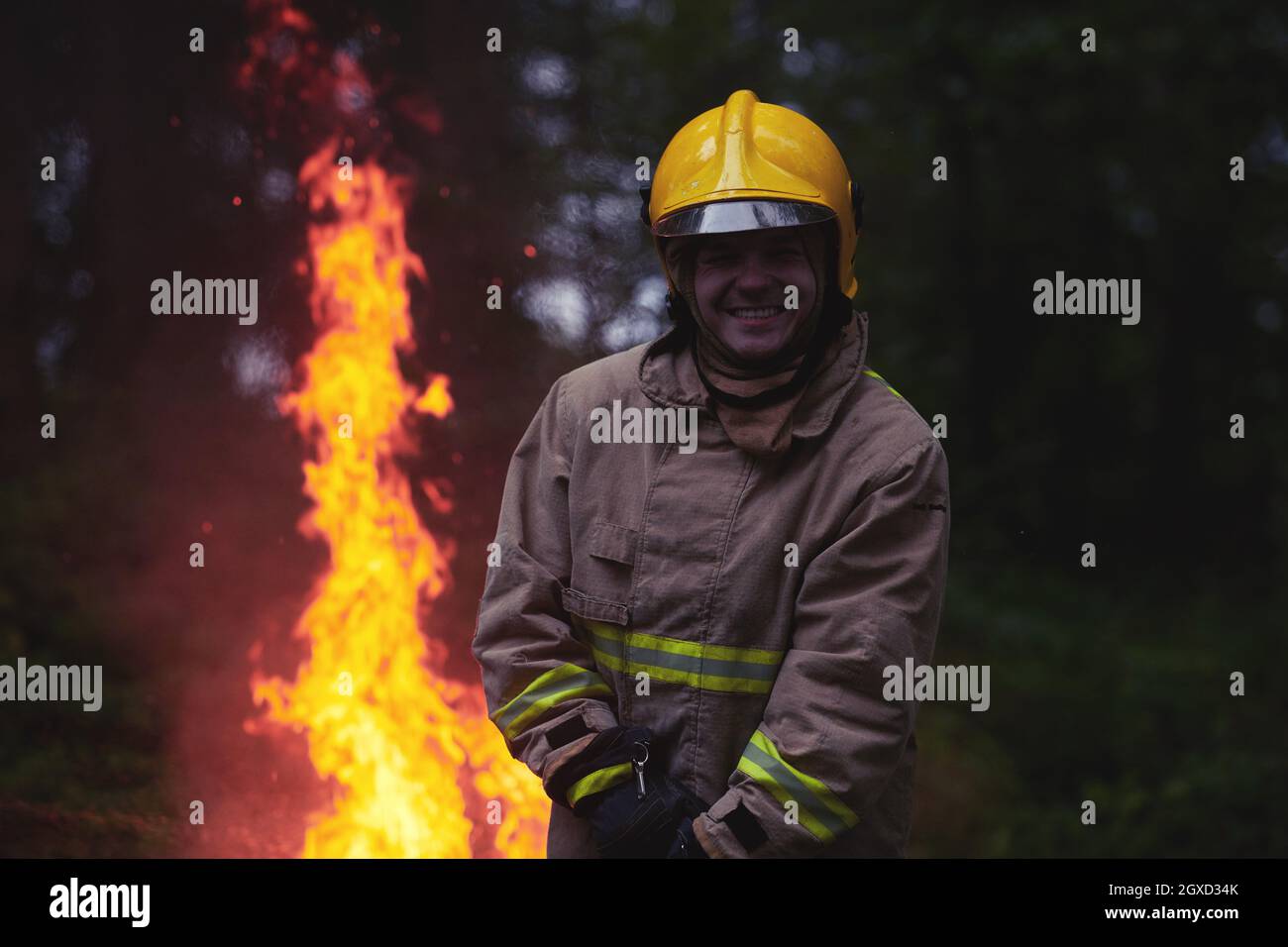 firefighter portrait on authentic fire location in forest Stock Photo ...